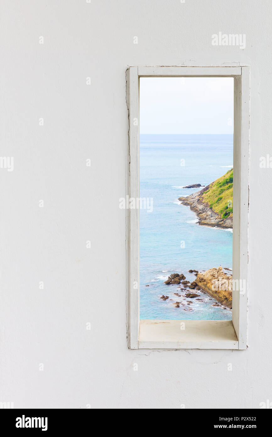 White wall window with sea beach view, vertical landscape concept ...