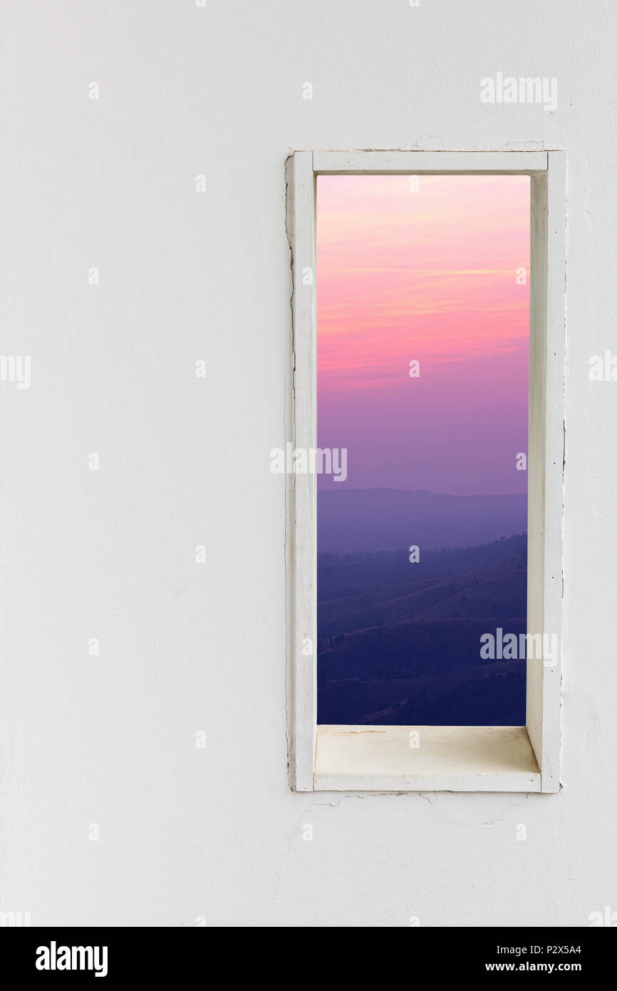 White wall window with sunset mountain view, vertical landscape concept ...