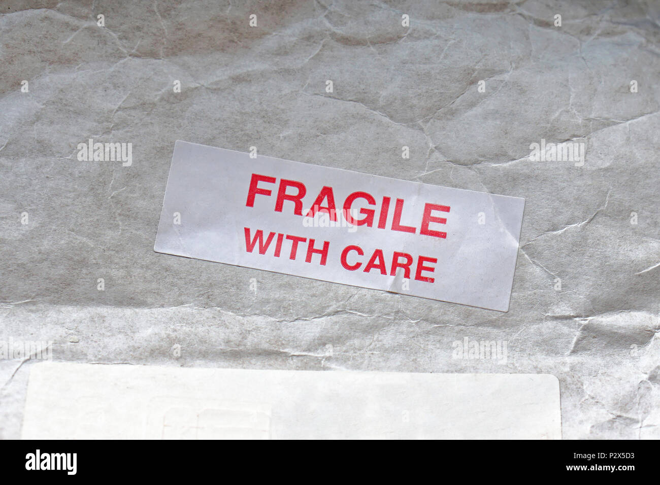 Fragile with care sticker at mail post Stock Photo - Alamy