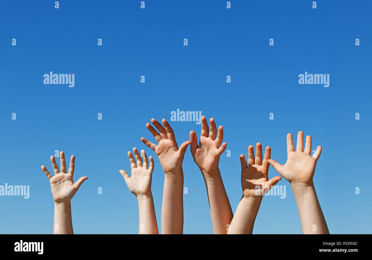Happy kids arms raised together hi-res stock photography and images - Alamy
