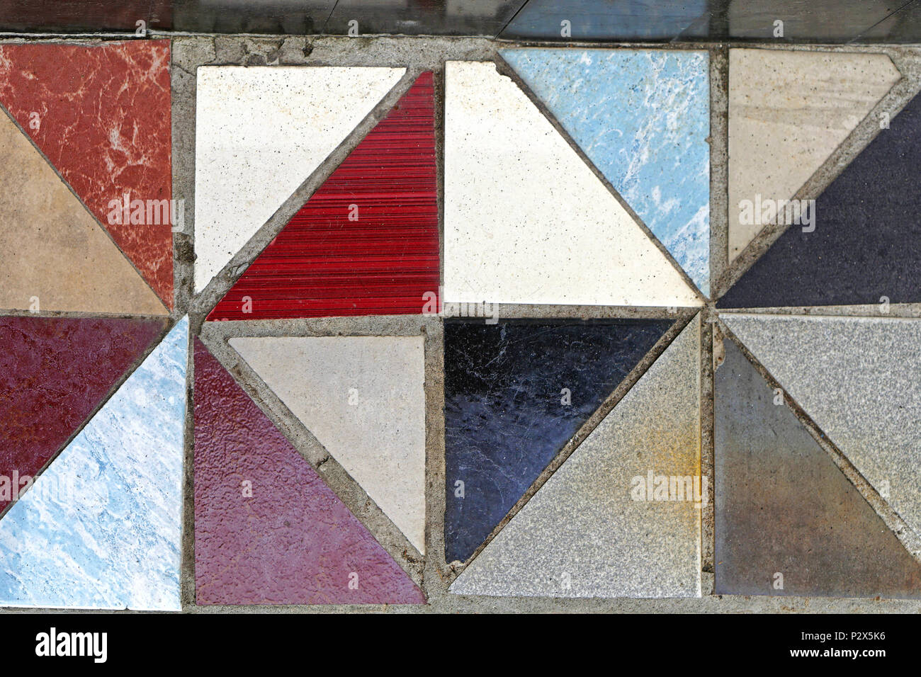 Grunge floor tiles made from triangular pieces Stock Photo - Alamy