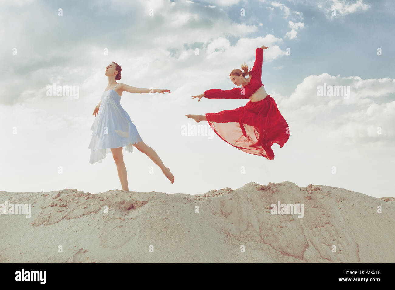 Two beautiful female dancers dancing in the desert Stock Photo - Alamy
