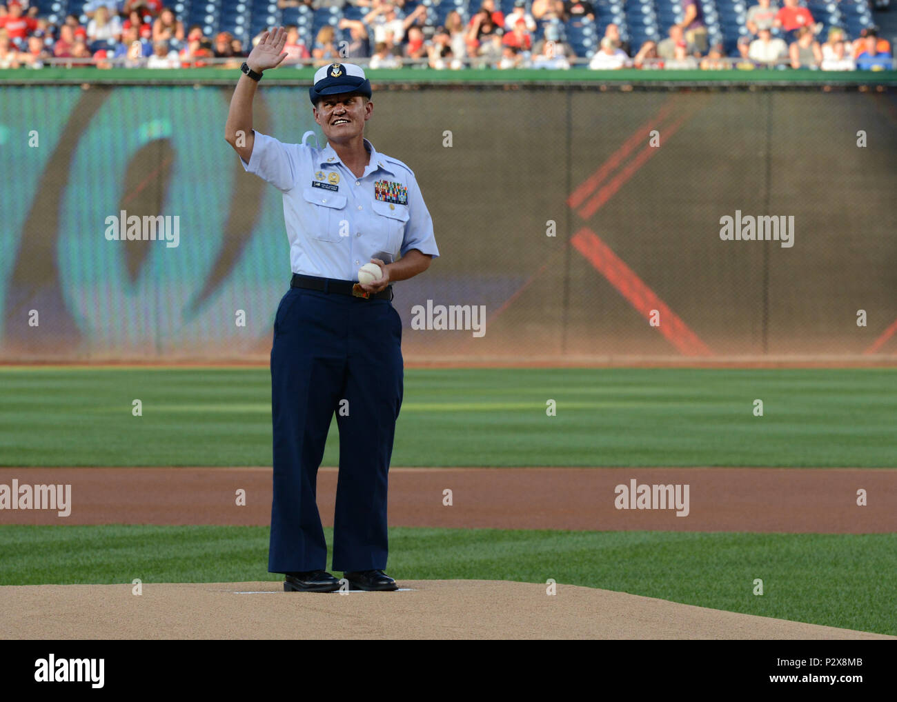 Master Chief Petty Officer Leilani Cale-Jones presents the game ball at ...
