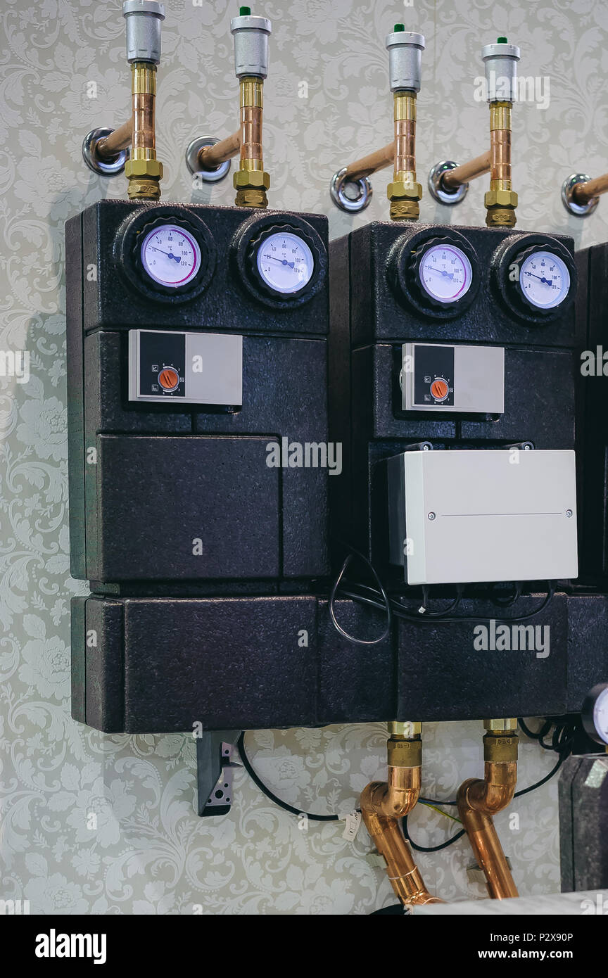Thermometer, pipes and faucet valves of heating system in a boiler room ...