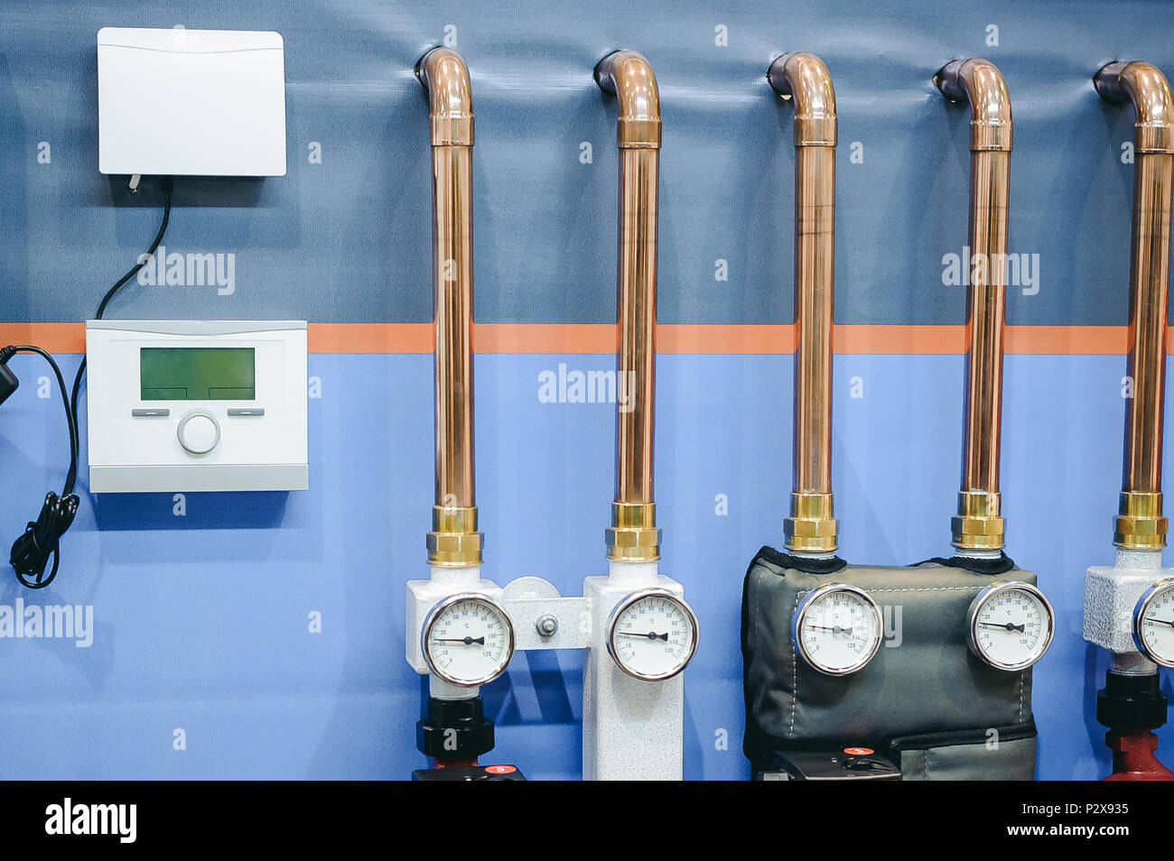 Thermometer, pipes and faucet valves of heating system in a boiler room ...