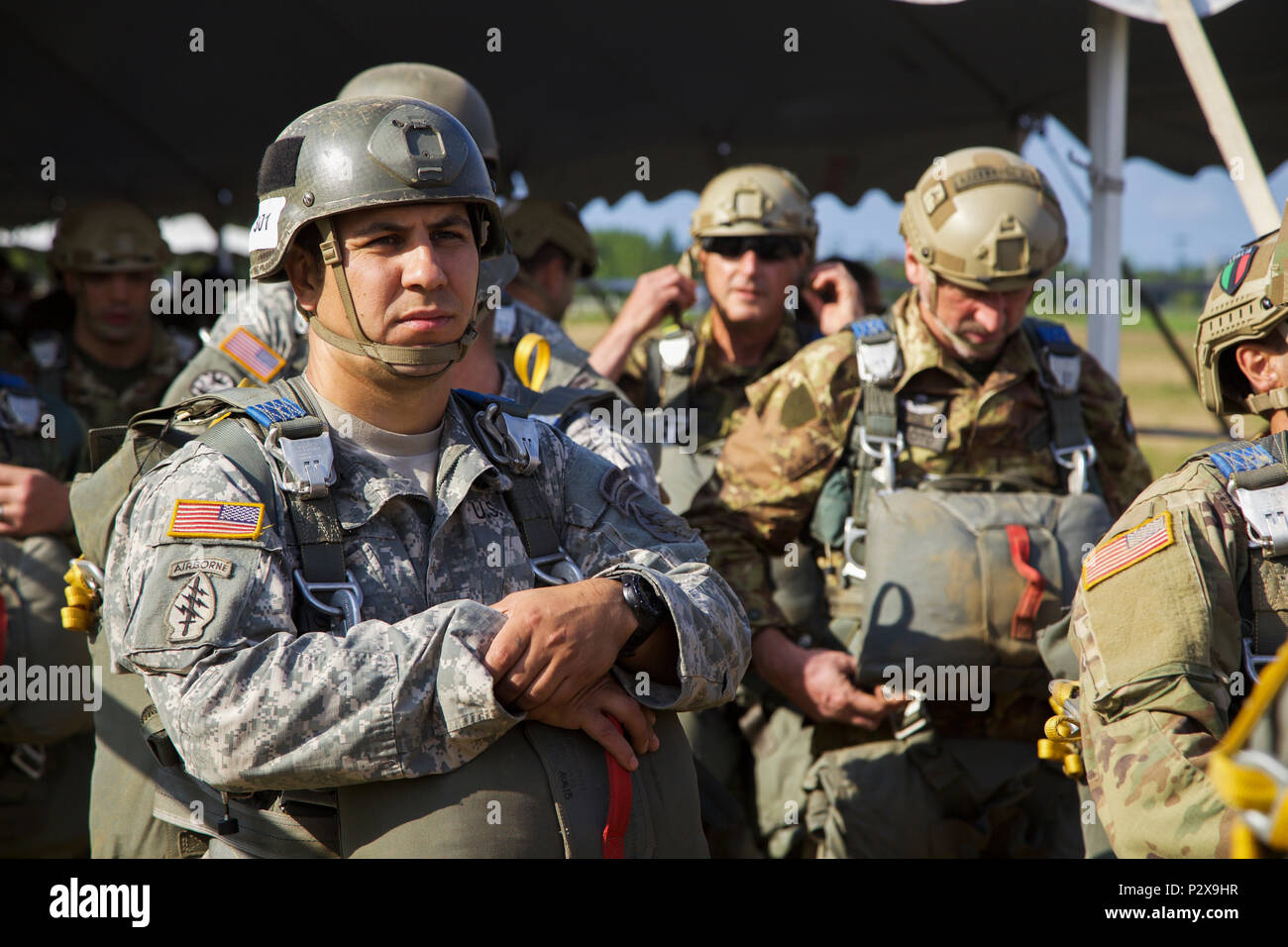 A group of U.S. Army and Partner Nation Paratroopers waits to be JMPI ...