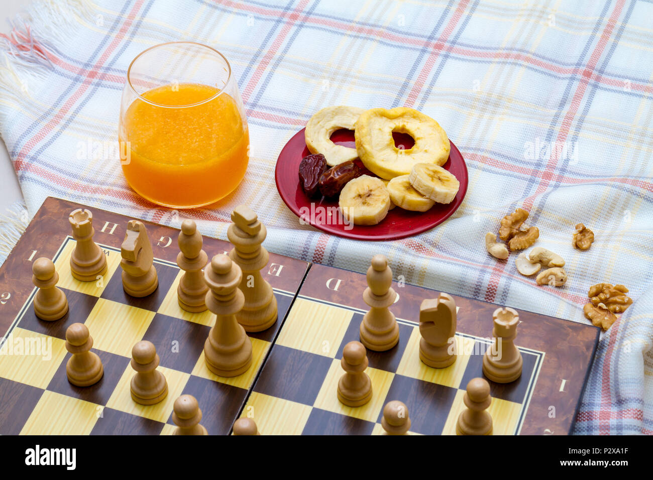Healthy eating concept. Mix of dried fruits and nuts with chess pieces ...