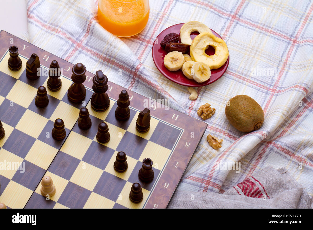 Healthy eating concept. Mix of dried fruits and nuts with chess pieces ...