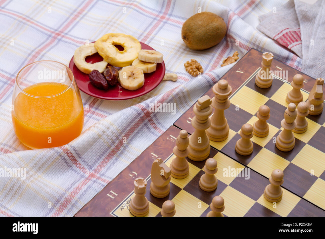 Healthy eating concept. Mix of dried fruits and nuts with chess pieces ...