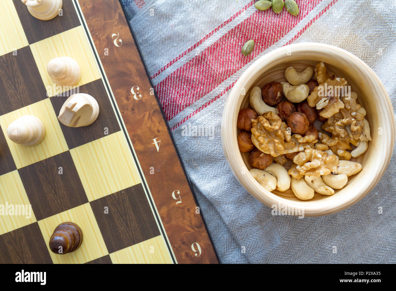 Healthy eating concept. Mix of dried fruits and nuts with chess pieces ...