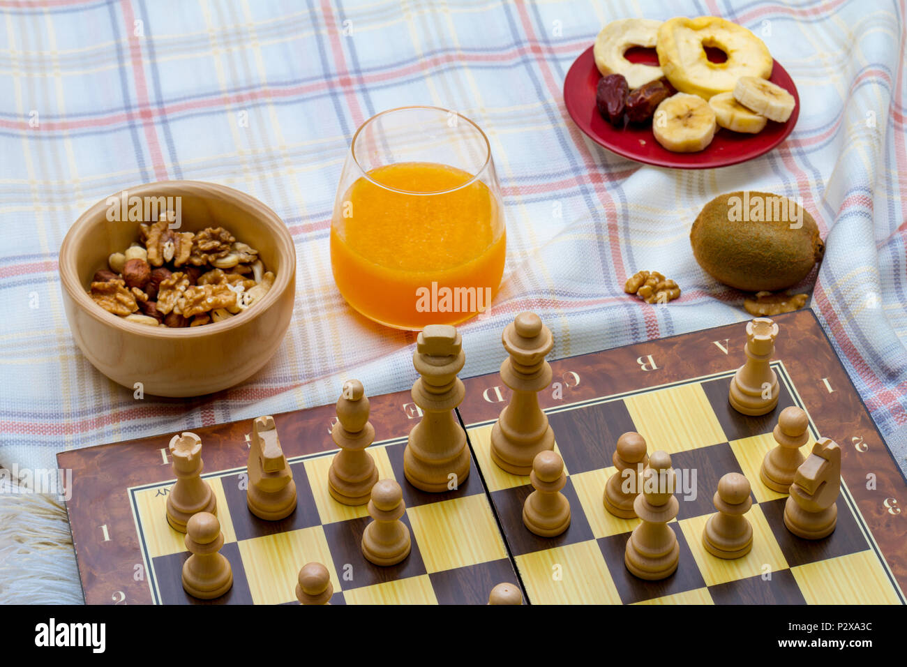 Healthy eating concept. Mix of dried fruits and nuts with chess pieces ...