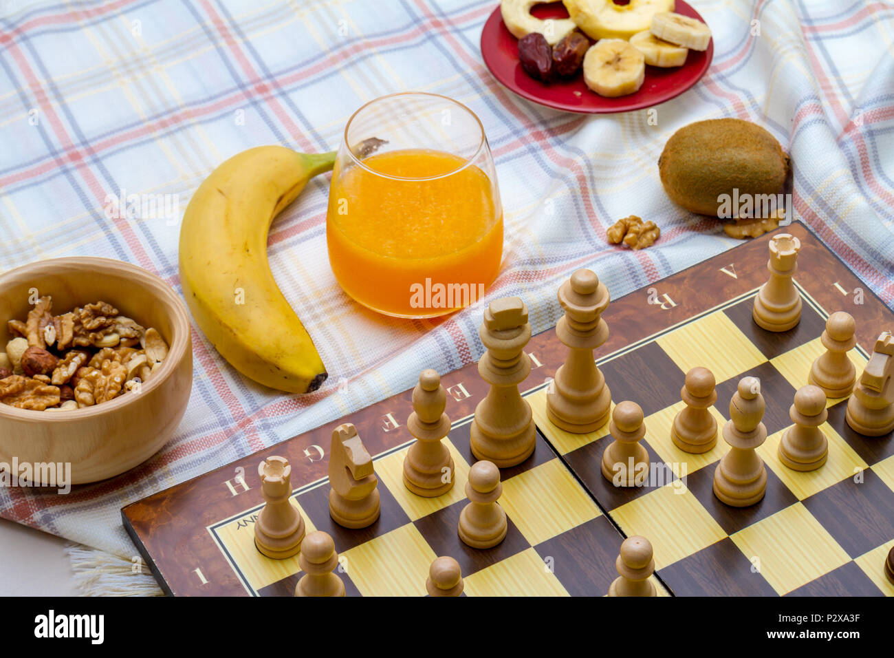 Healthy eating concept. Mix of dried fruits and nuts with chess pieces ...