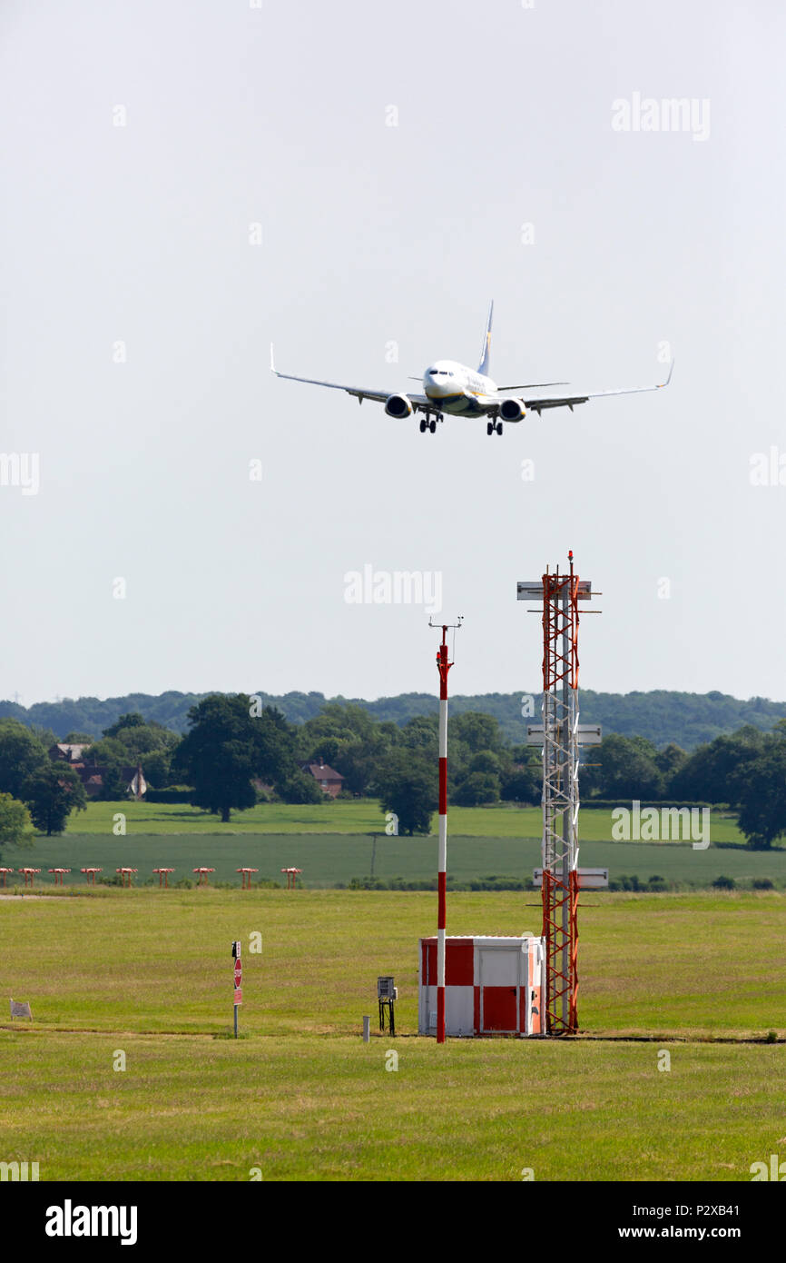 A commercial jet airliner landing at a large airport. Airport landing ...