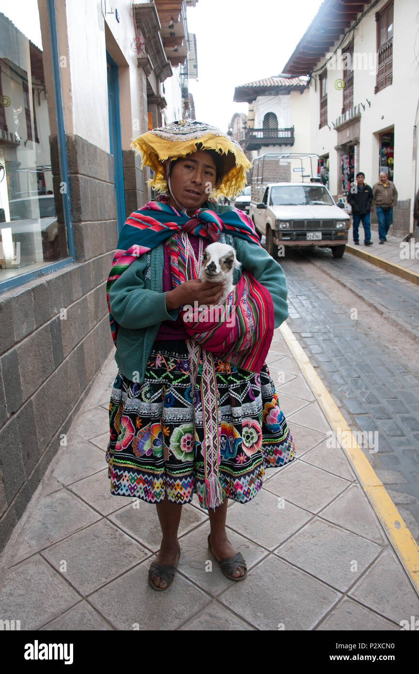Peruvian woman in traditional costume holding her lamb in Cusco Peru ...