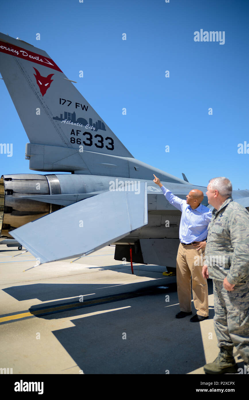 U.S. Sen. Cory Booker points to the tail of the 177th Fighter Wing jet while talking with the ...