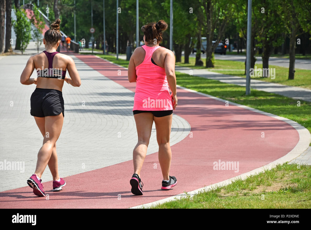 Women run on the running track Stock Photo - Alamy