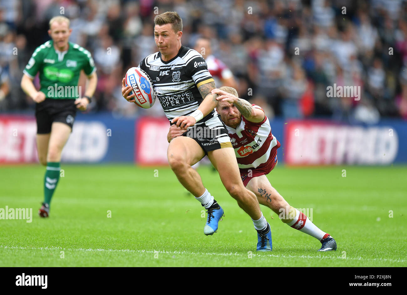 Hull FC's Jamie Shaul is tackled by Wigan Warriors' Sam Tomkins during ...