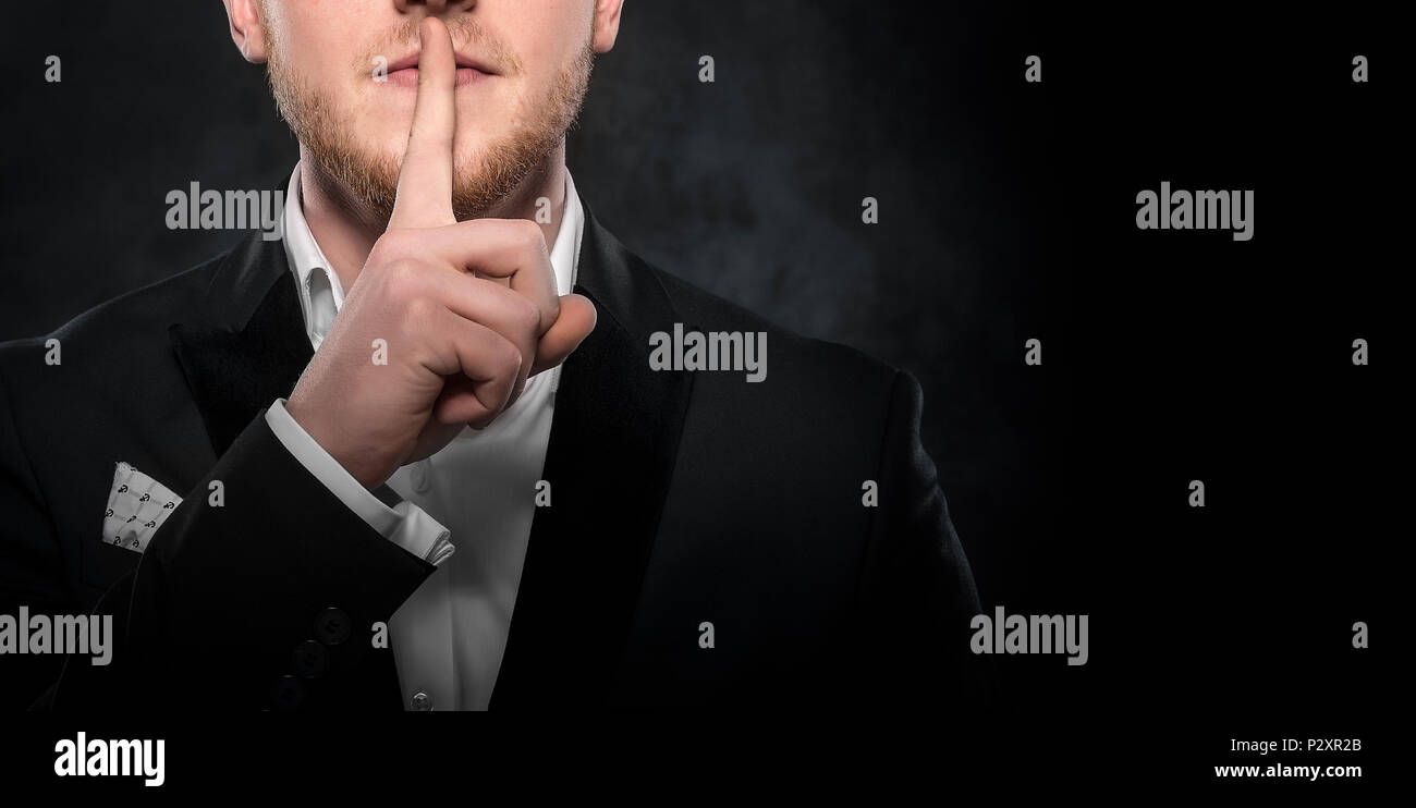 Man gesturing silent Stock Photo - Alamy