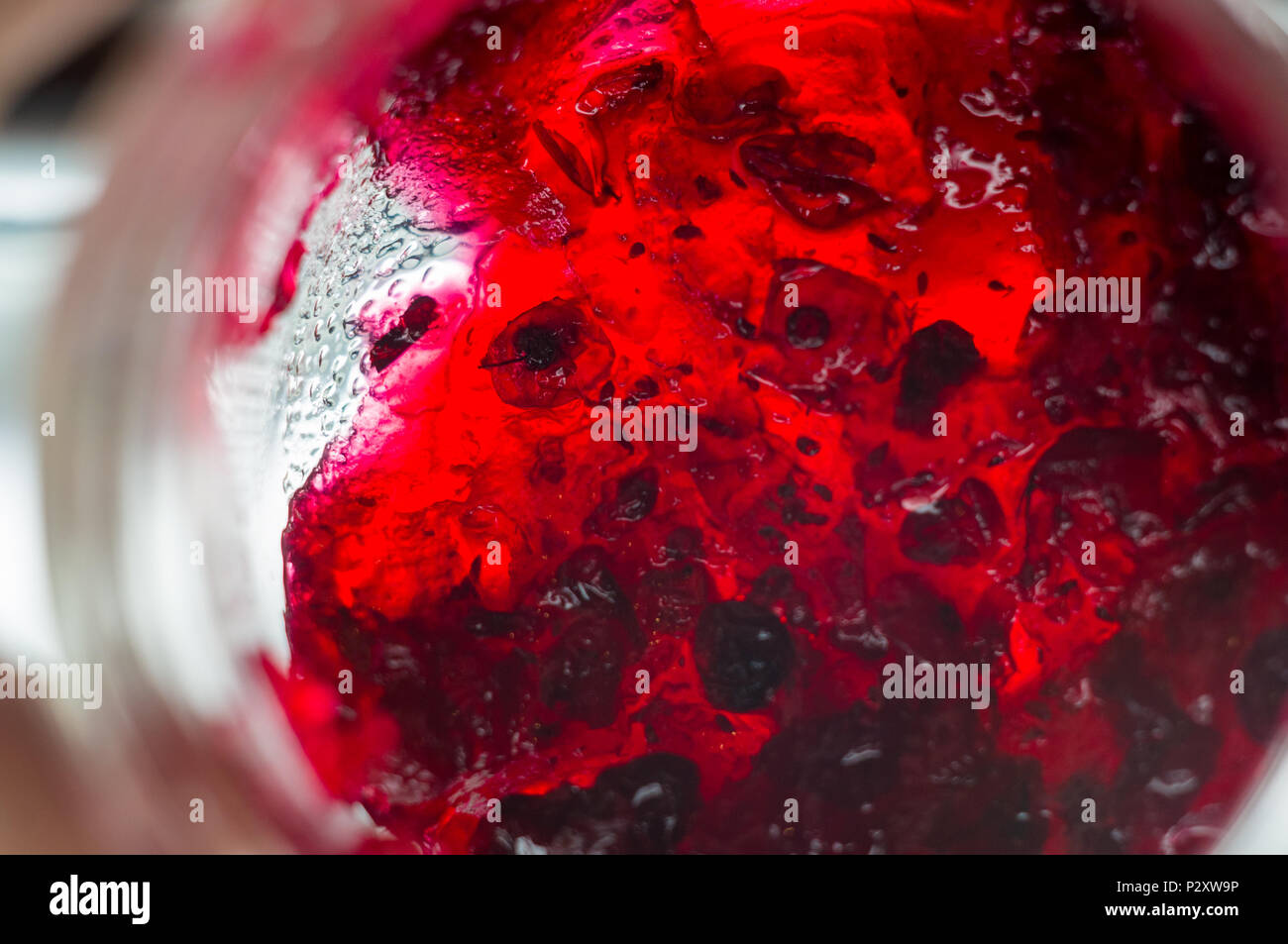 Bright translucent red currant jam in a glass jar, close-up, macro ...