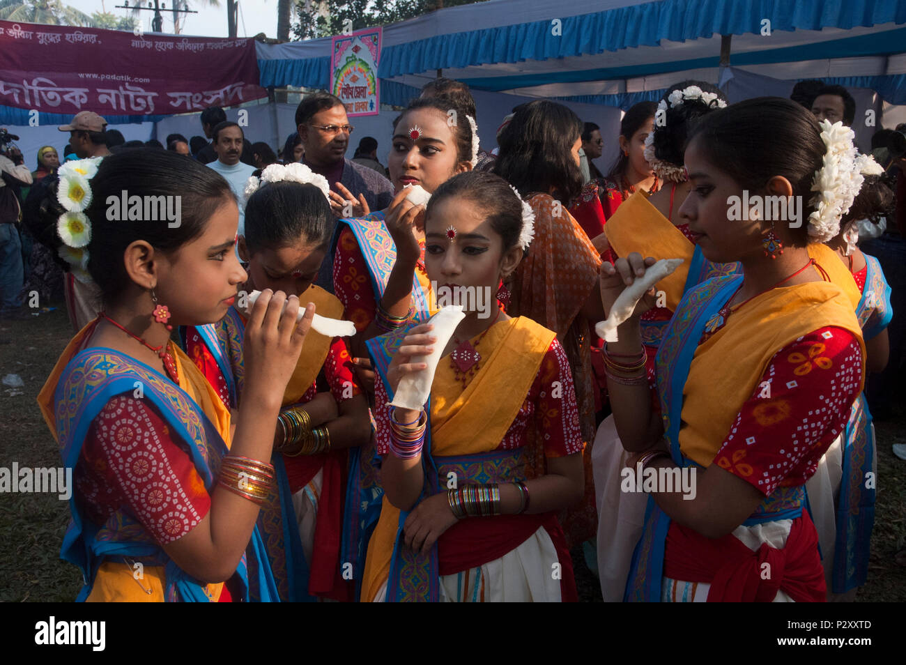 Girls eat Pitha at Poush Mela 1414 and celebrating Winter Festival at ...