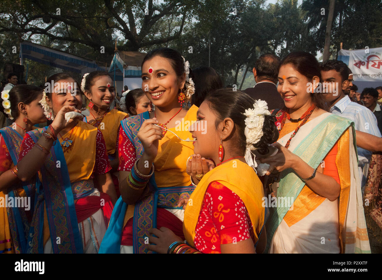 Girls eat Pitha at Poush Mela 1414 and celebrating Winter Festival at ...