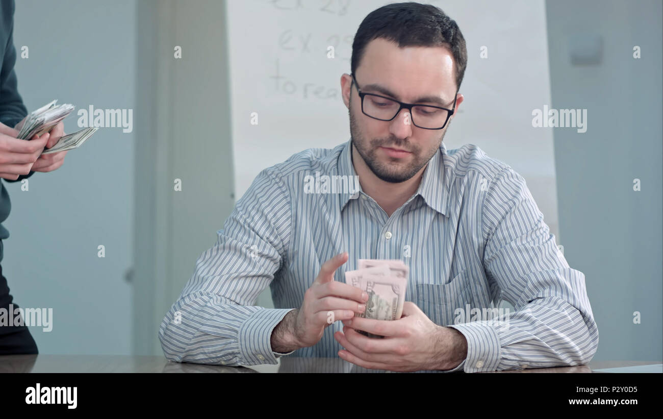 Teacher taking money and counting dollar bills Stock Photo - Alamy