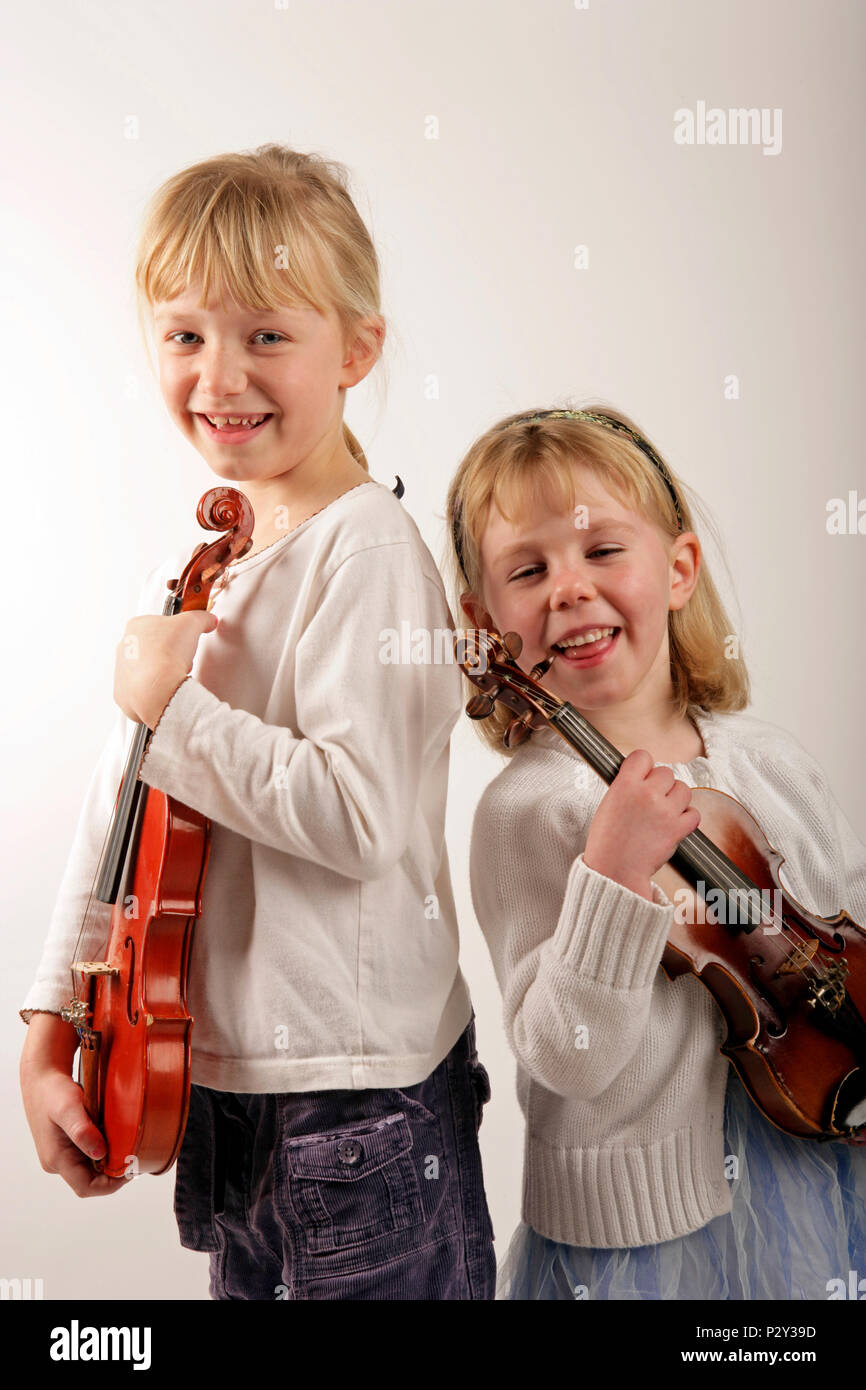 two girls holding their violins - generic Stock Photo - Alamy