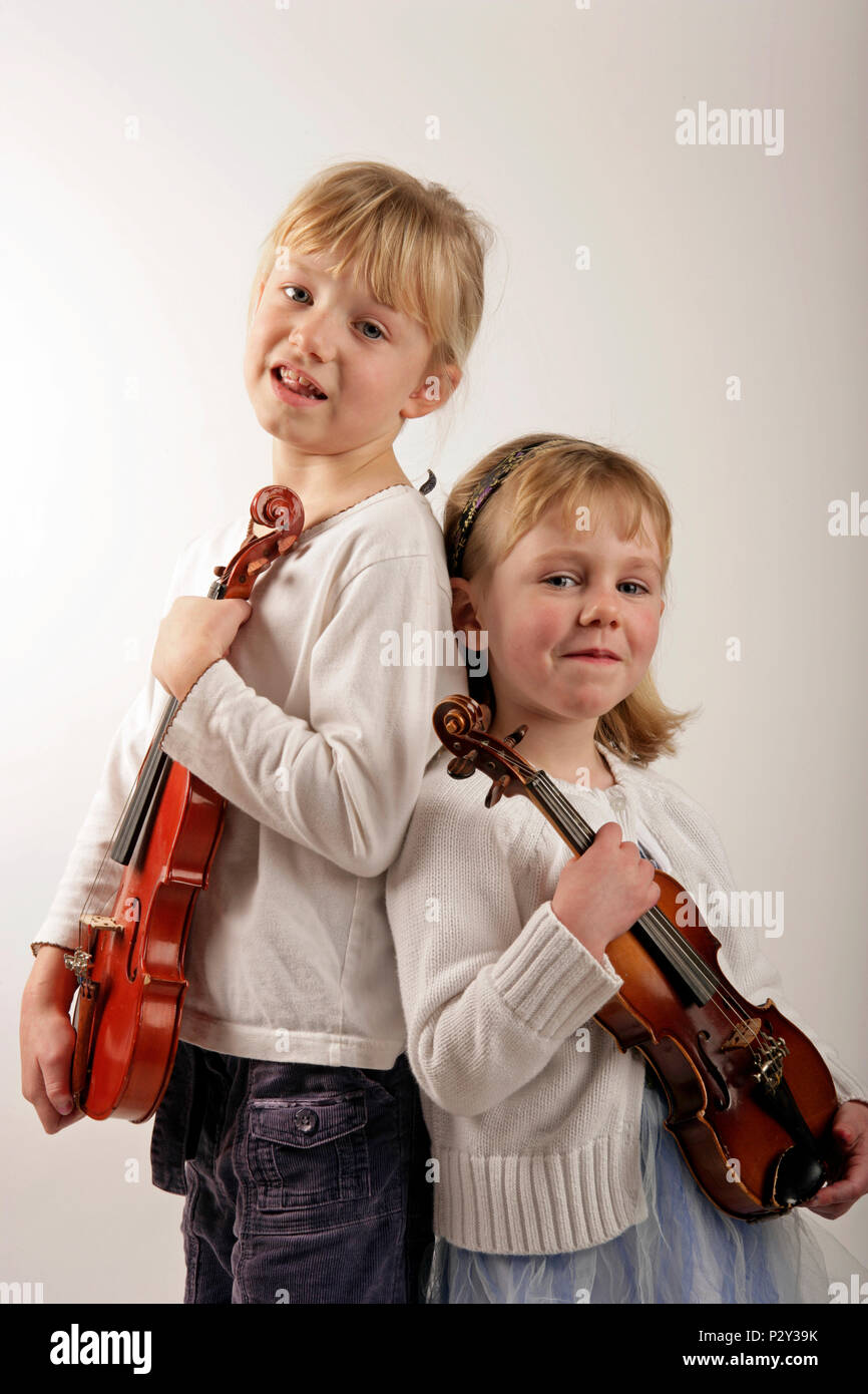 two young girls holding their violins Stock Photo - Alamy
