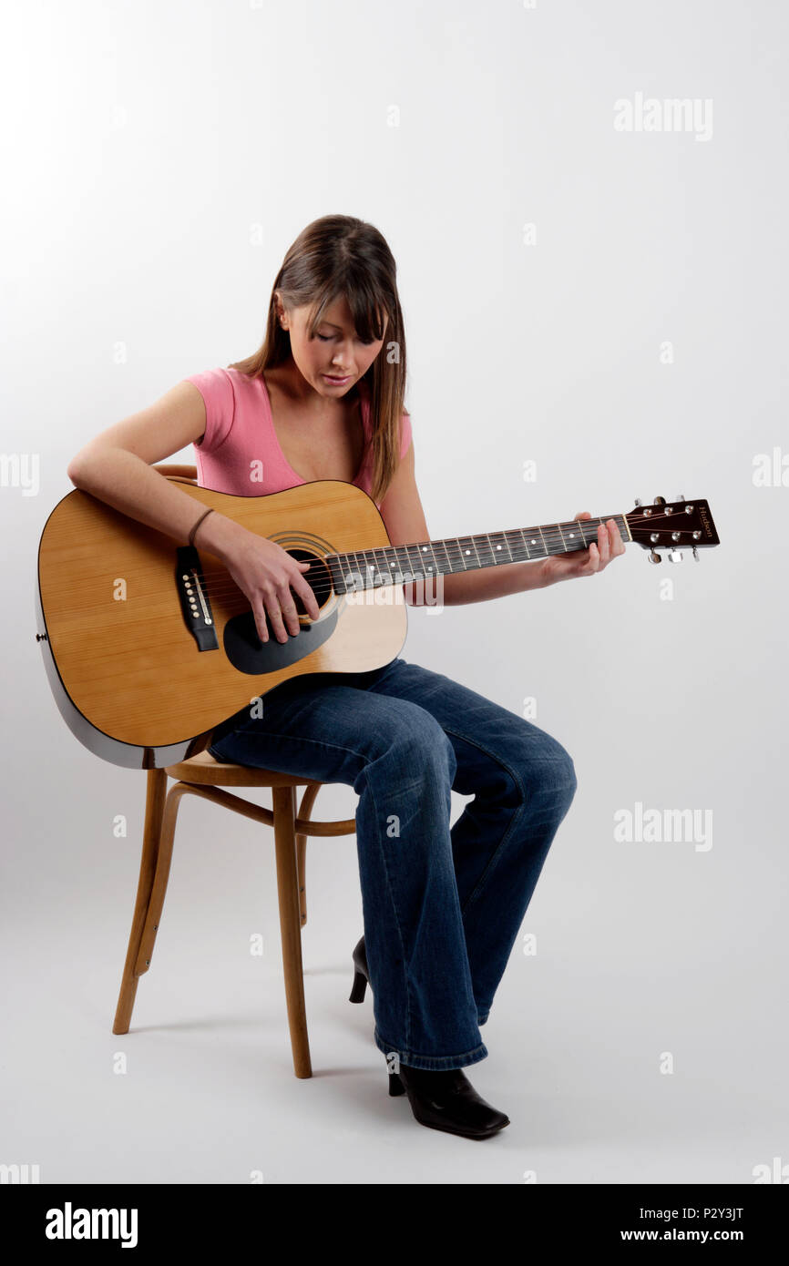 Strumming the open strings of the guitar Stock Photo - Alamy