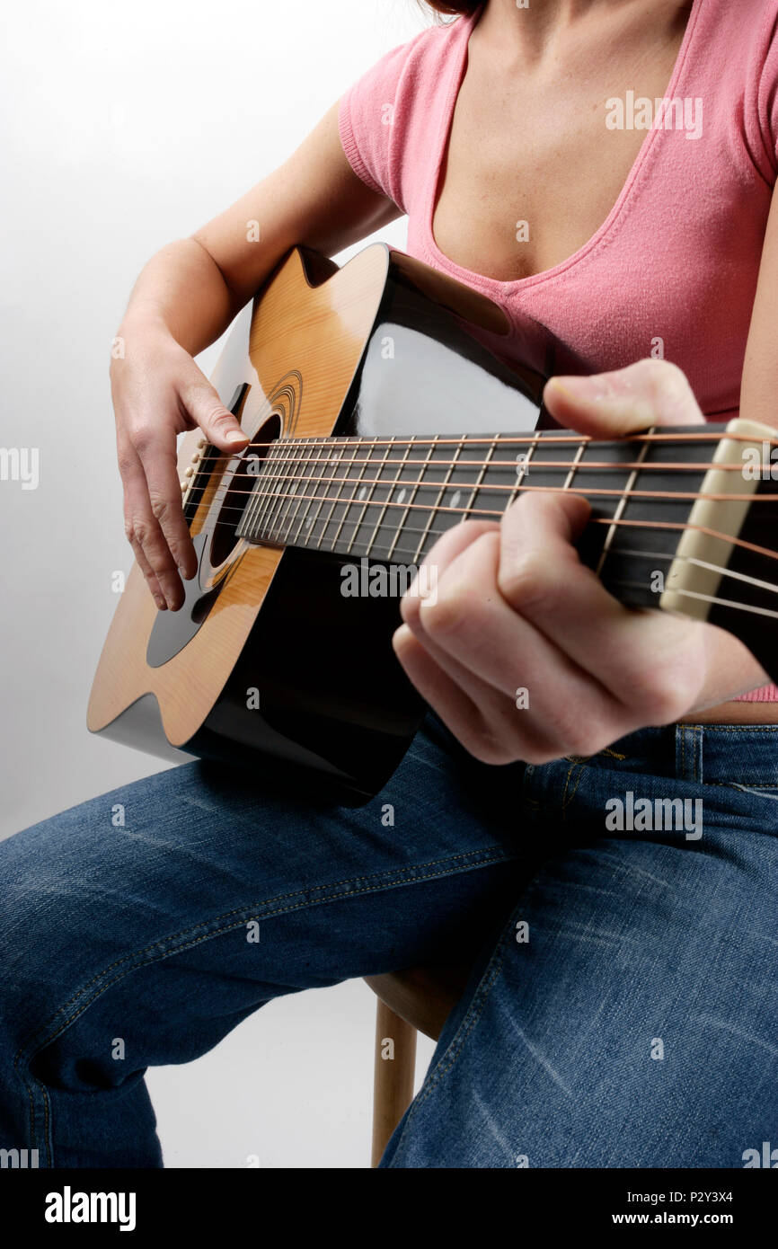 Young woman playing the guitar Stock Photo - Alamy