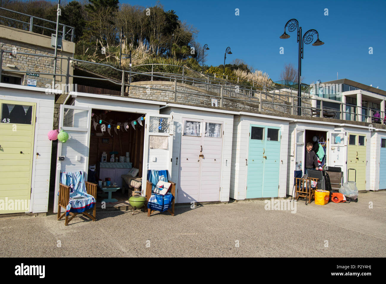 Lime Regis England beach huts hut coloured colour light lights seat ...