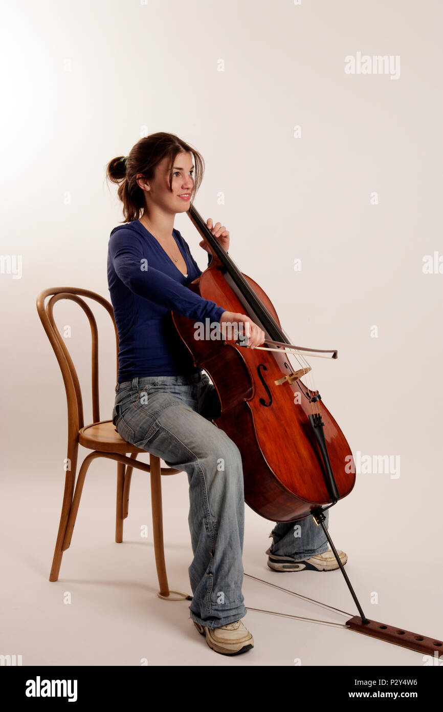 Young lady playing the cello, showing the playing position Stock Photo ...