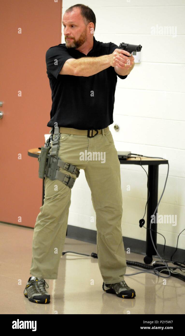 FBI Special Agent Michael Culloton demonstrates proper pistol handling ...