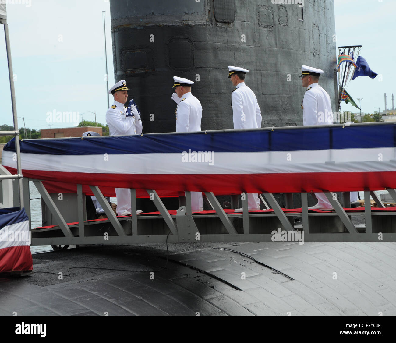 Capt. Paul Snodgrass receives the national ensign aboard USS Boise (SSN ...