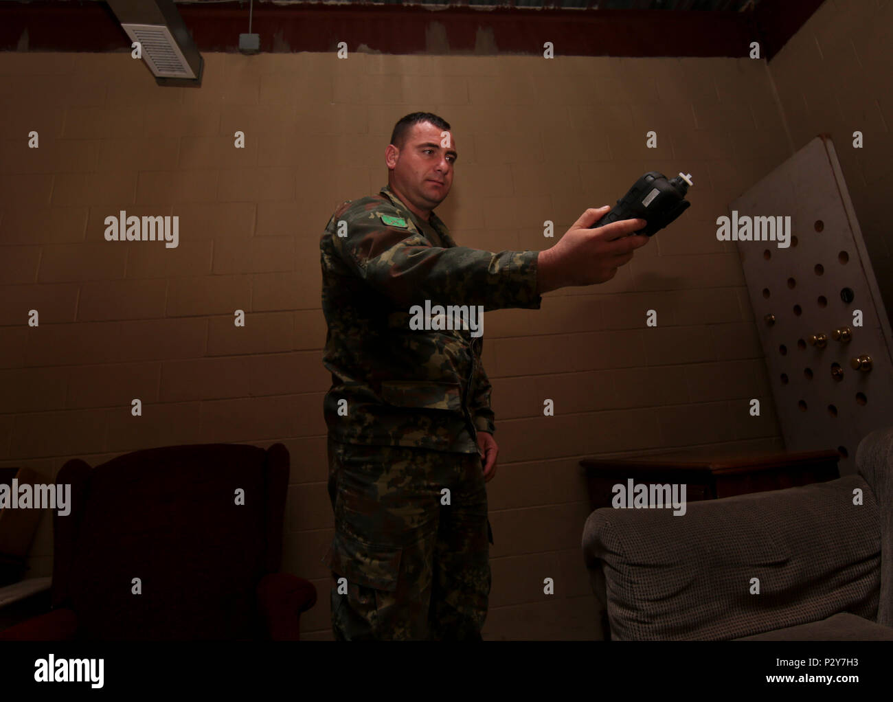 An Albanian soldier practices with detection gear during training with ...