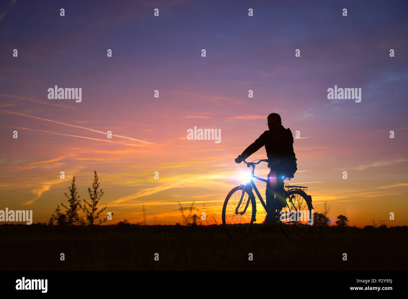 Man ride on bicycle. Rider silhouette on retro bike with sunset sky in ...