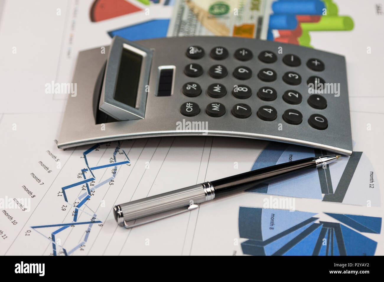 Pen, calculator and dollars are on the charts. Business background ...