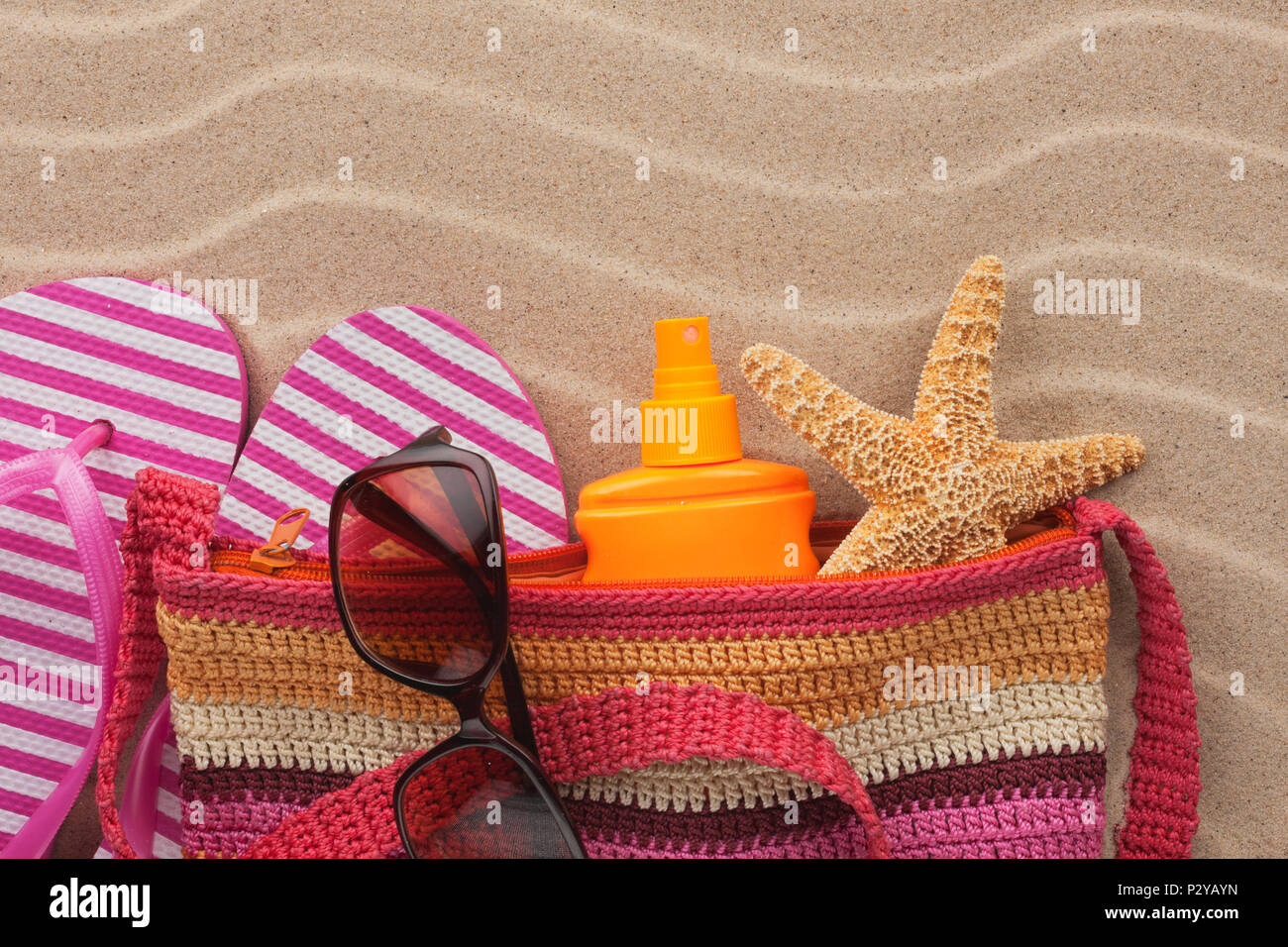 Beach bag with flip flops, sunglasses and sunscreen. Accessories for ...