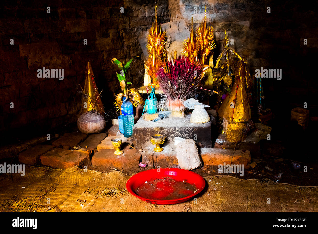 Sacrifice with flowers and incense in mysterious ancient old Phnom Krom ...