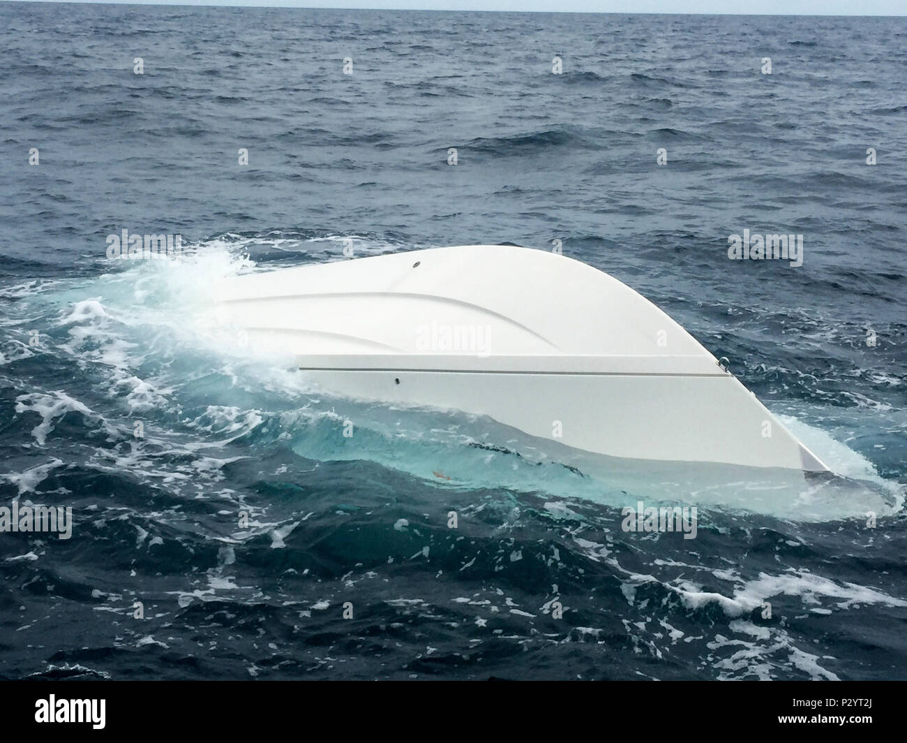 Show here is the capsized boat after four people were rescued by the ...