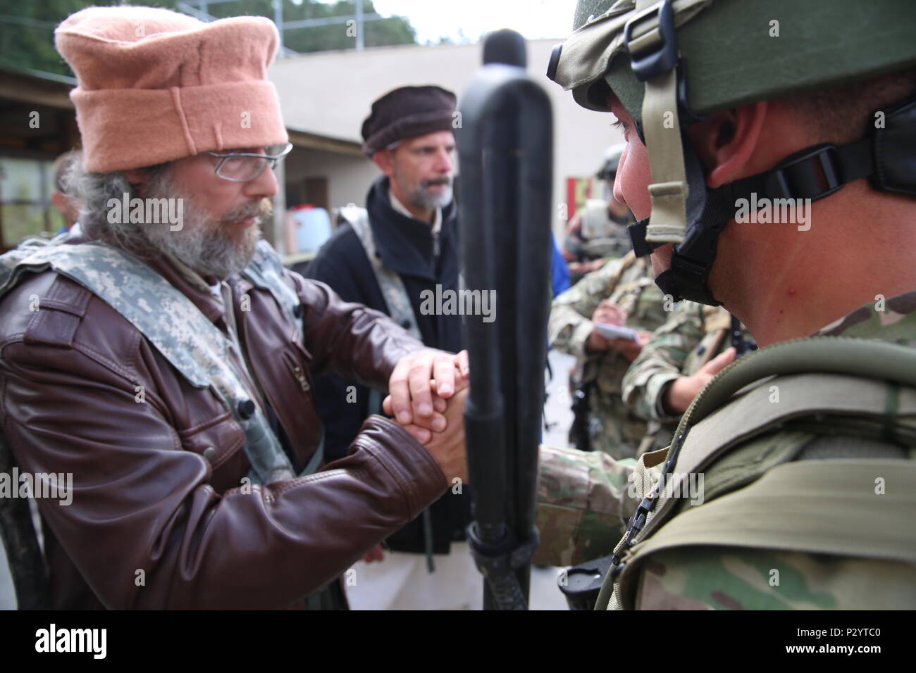 Georgian soldiers of the 32nd Light Infantry Battalion greet civilian ...