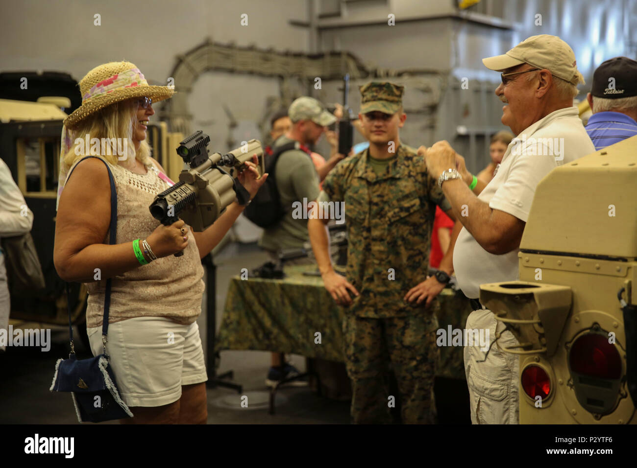 Visitors aboard the USS Oak Hill (LSD-51) pose for photos while touring ...