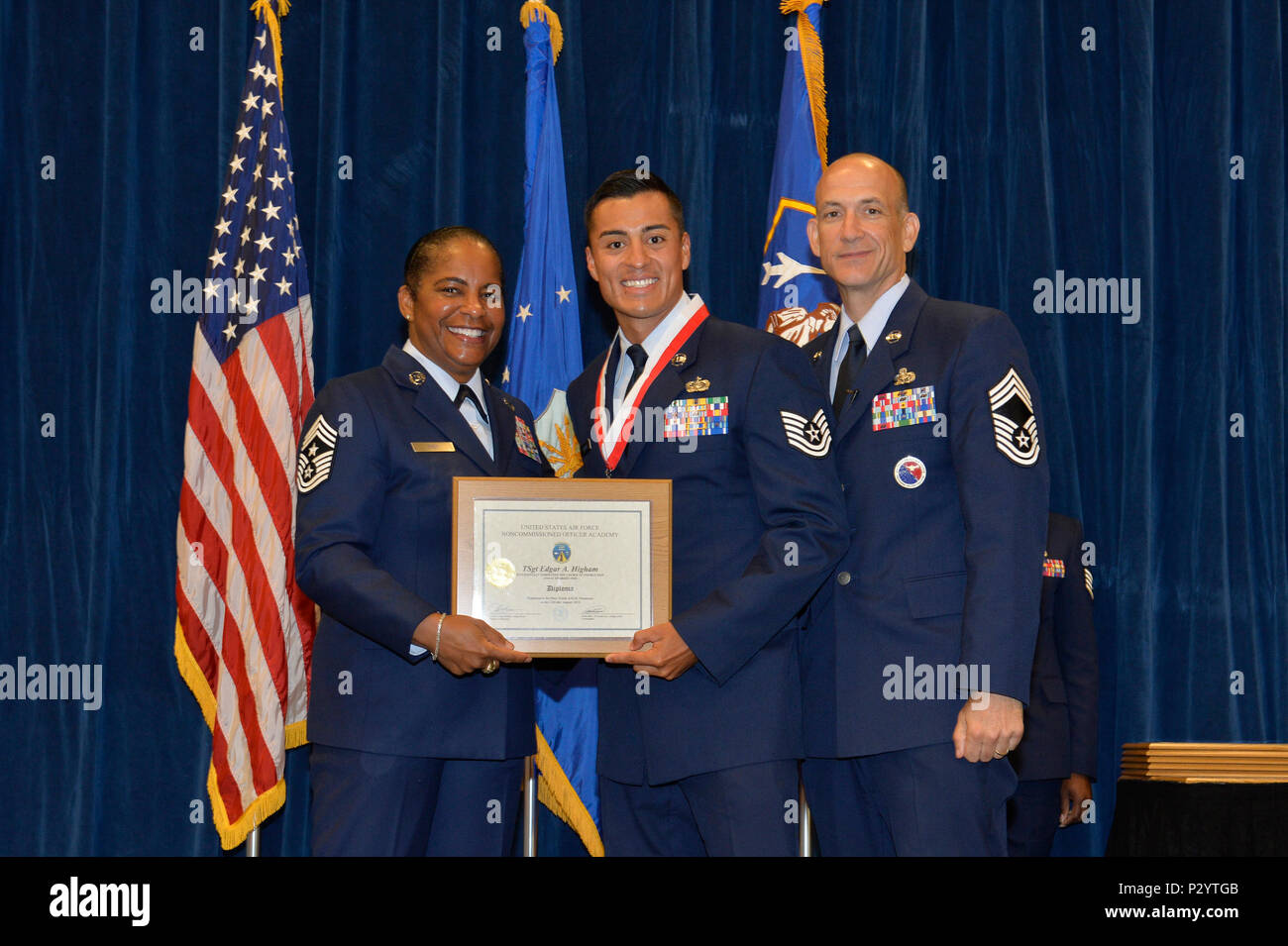 Tech. Sgt. Edgar Higham, right, receives the Distinguished Graduate ...