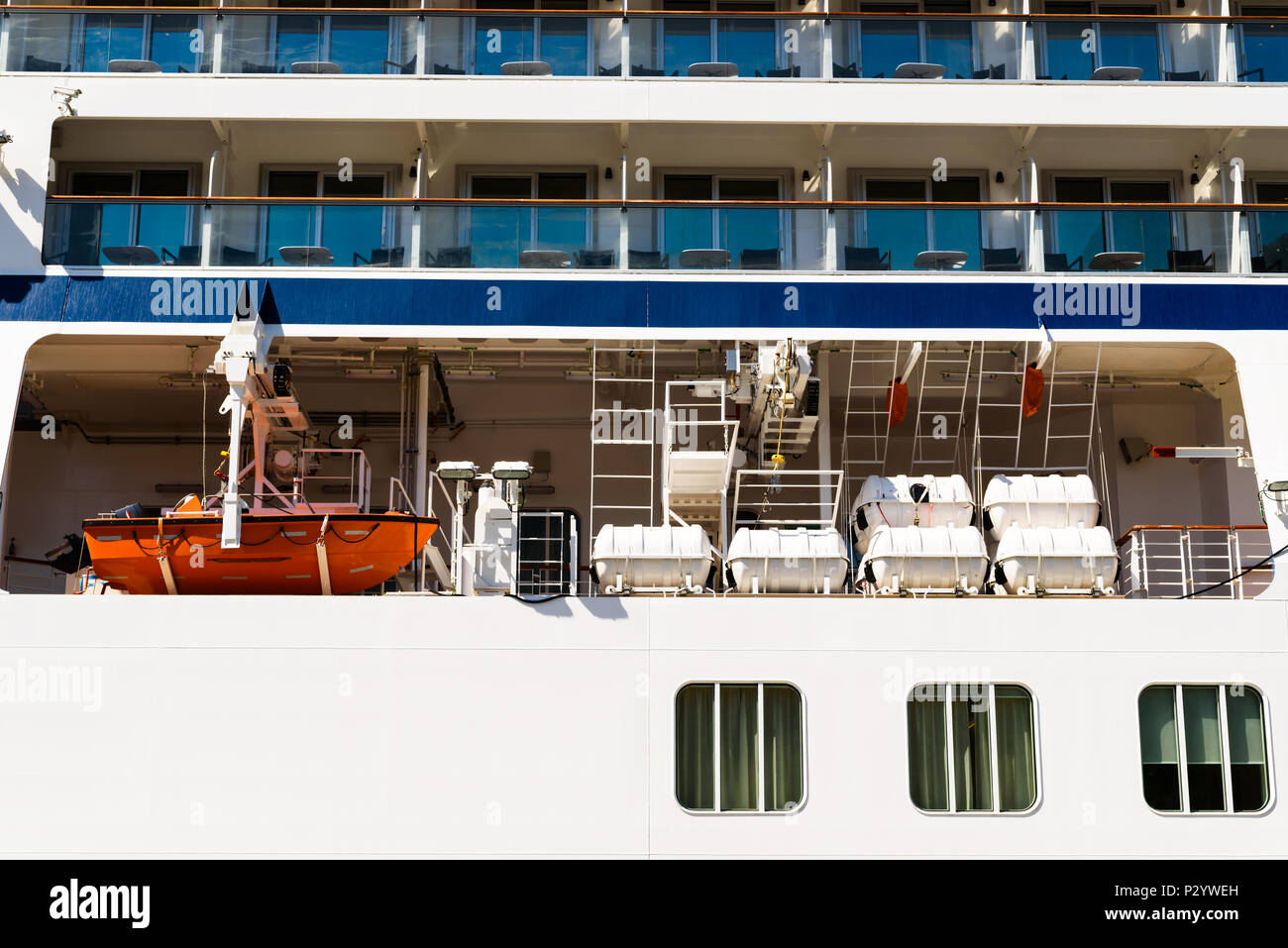 Orange lifeboat and inflatable life rafts on a white cruise ship Stock ...