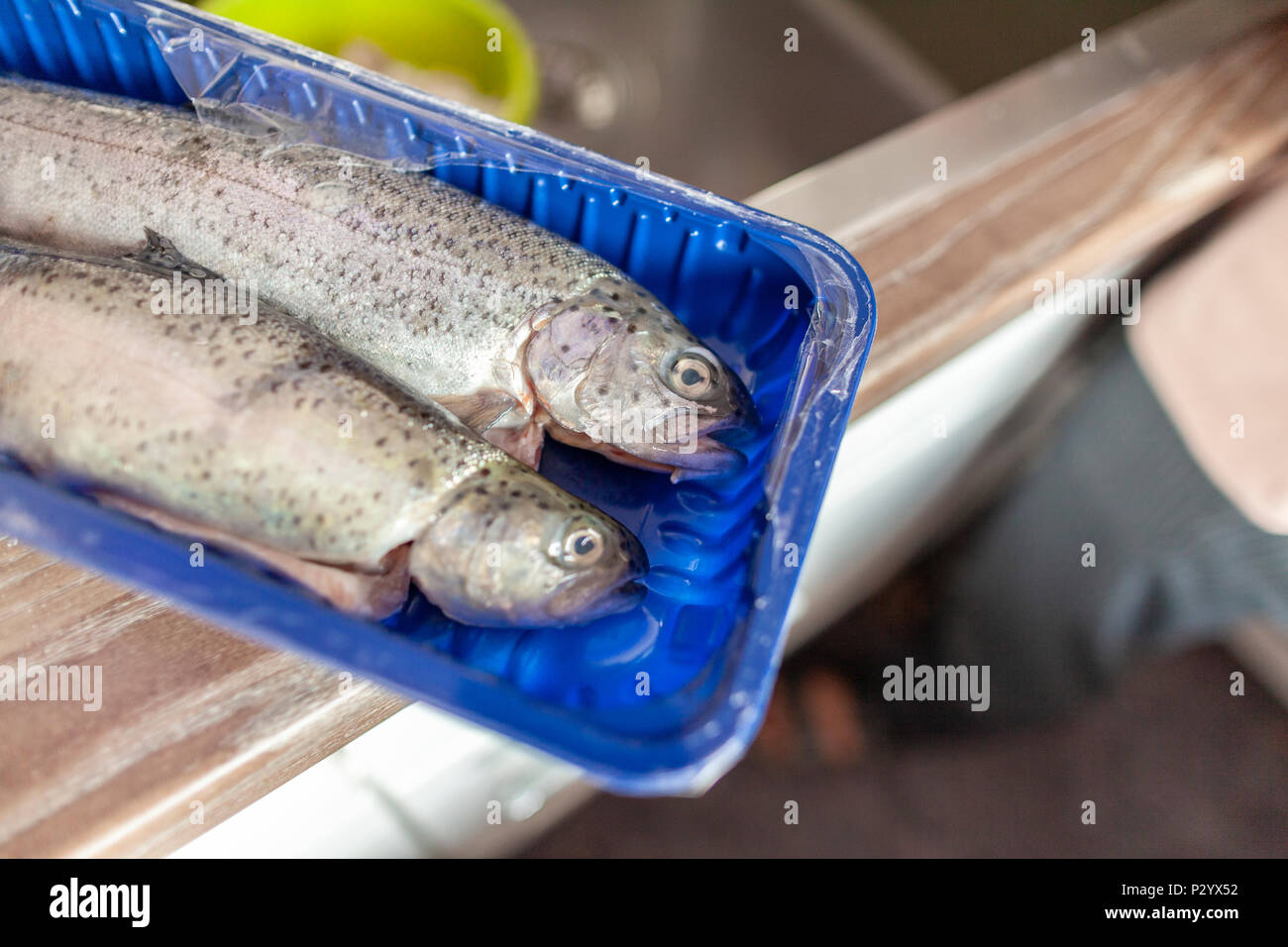 Fresh fish lies in a blue package Stock Photo - Alamy