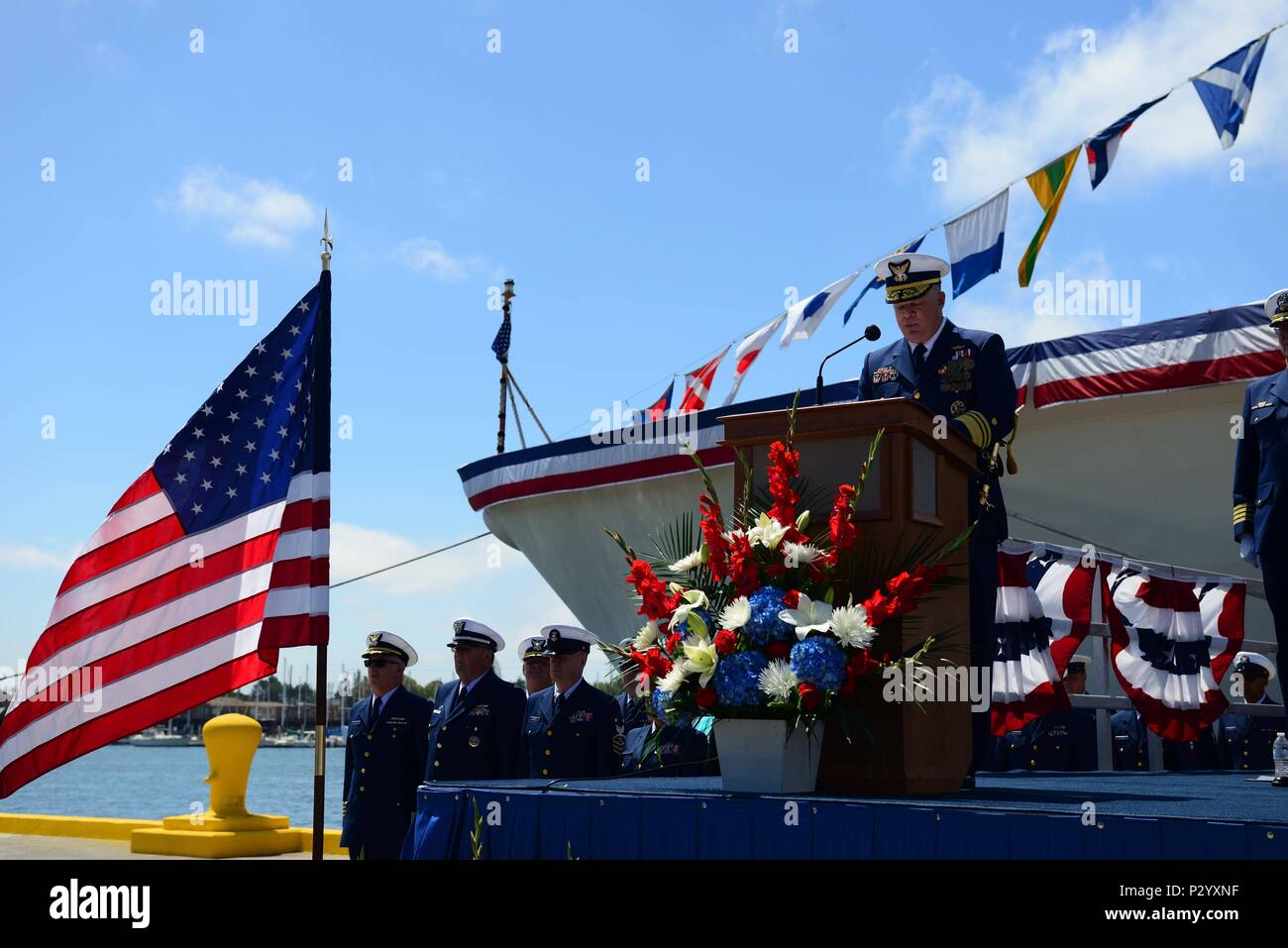 Vice Adm. Fred M. Midgette speaks to an assembled audience of guests ...