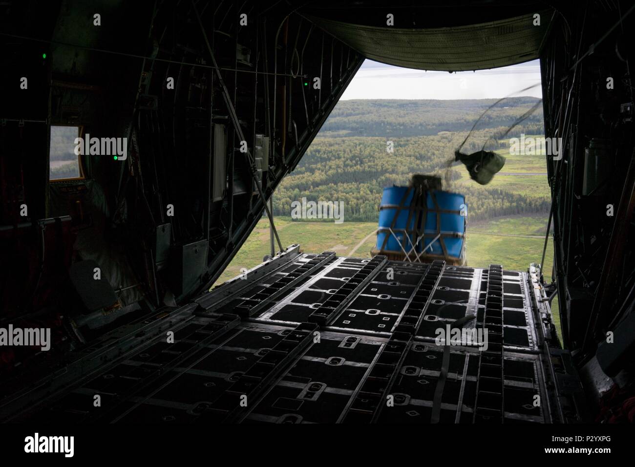 A container delivery system bundle drops from a C-130 Hercules during ...