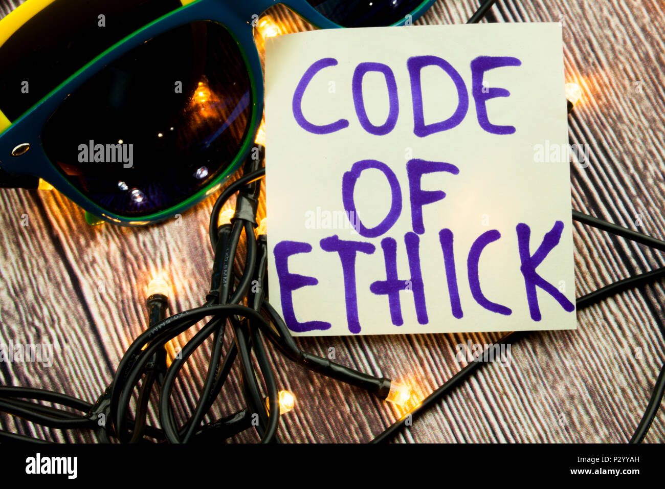 Code of ethics handwritten on light vanilla note paper with blue color ...