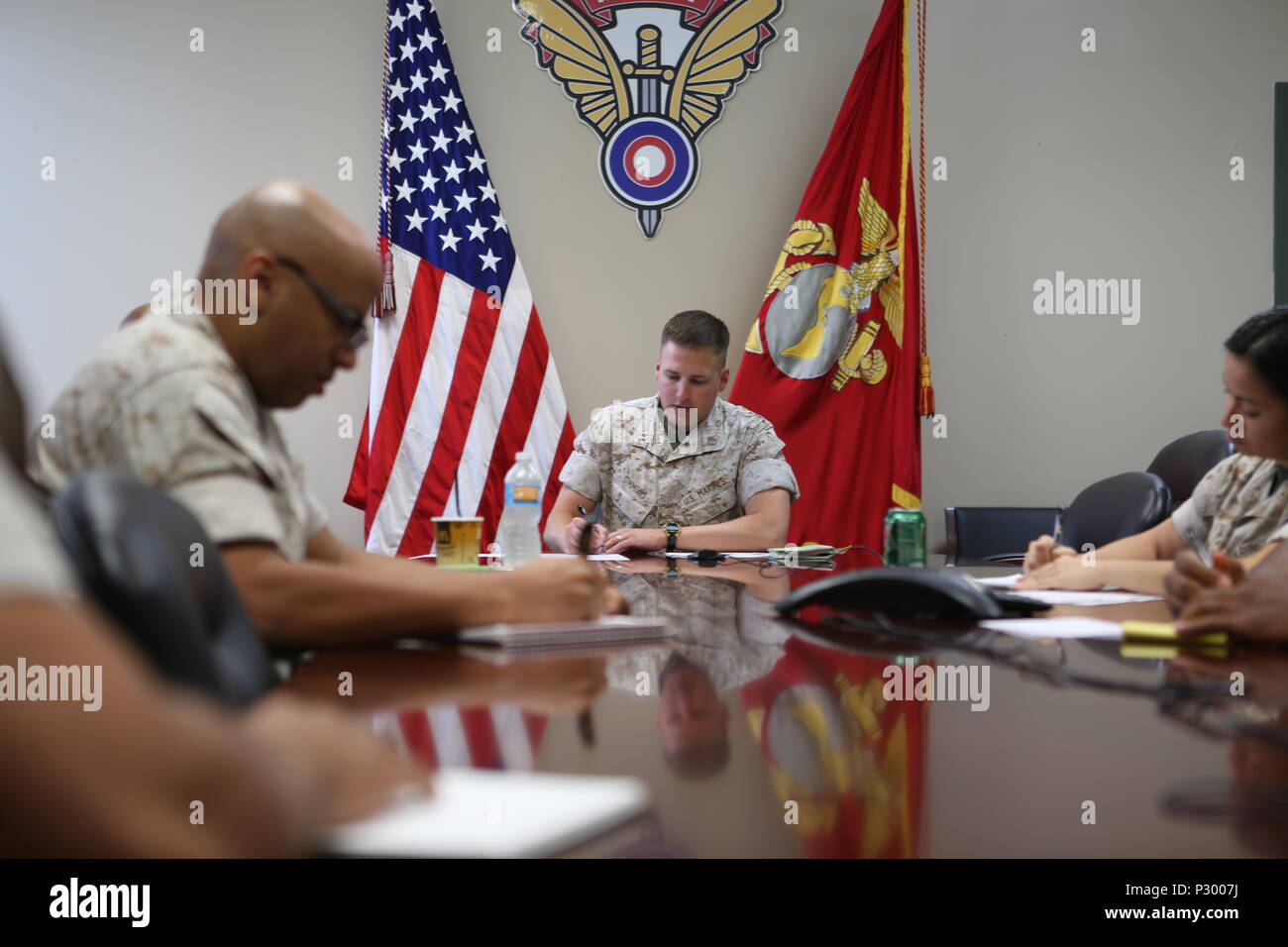 Capt. Stephen B. Simmons prepares to hold a conference call at Marine ...