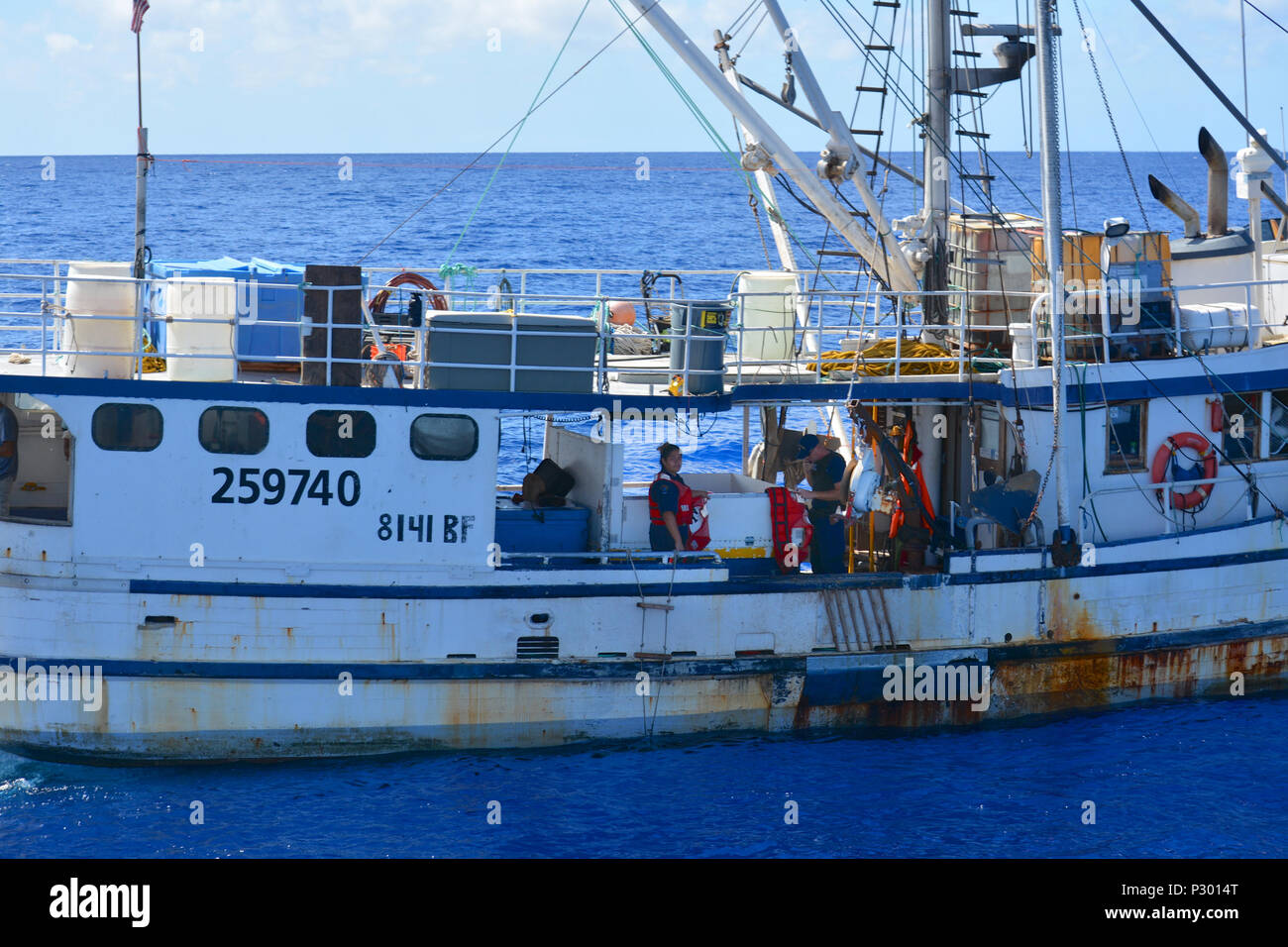The crew of the USCGC Galveston Island (WPB-1349), with an officer from ...